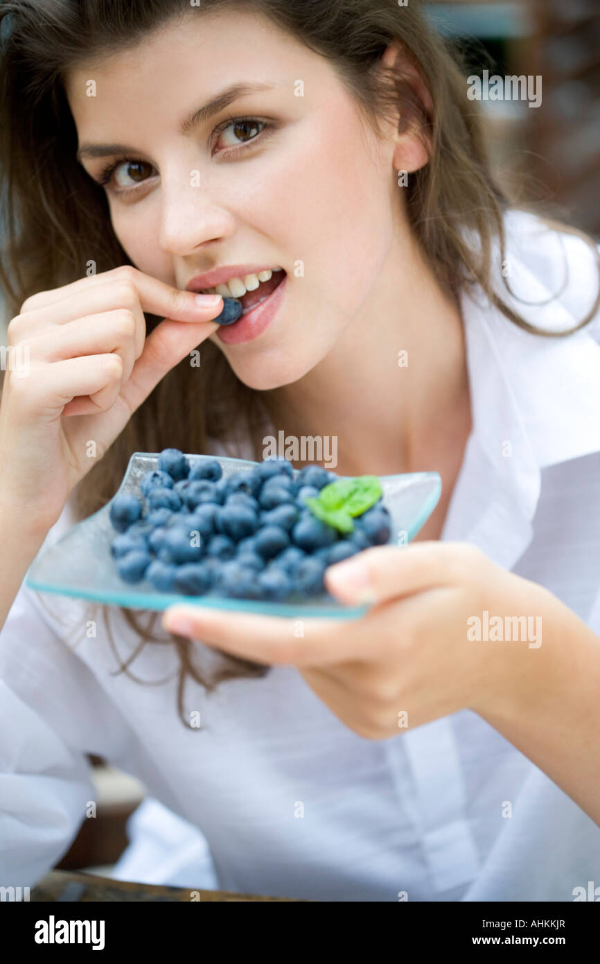 woman eating blueberries Stock Photo - Alamy