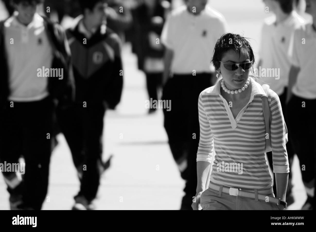 Without uniform student walking with students in uniform. Plaza del ...