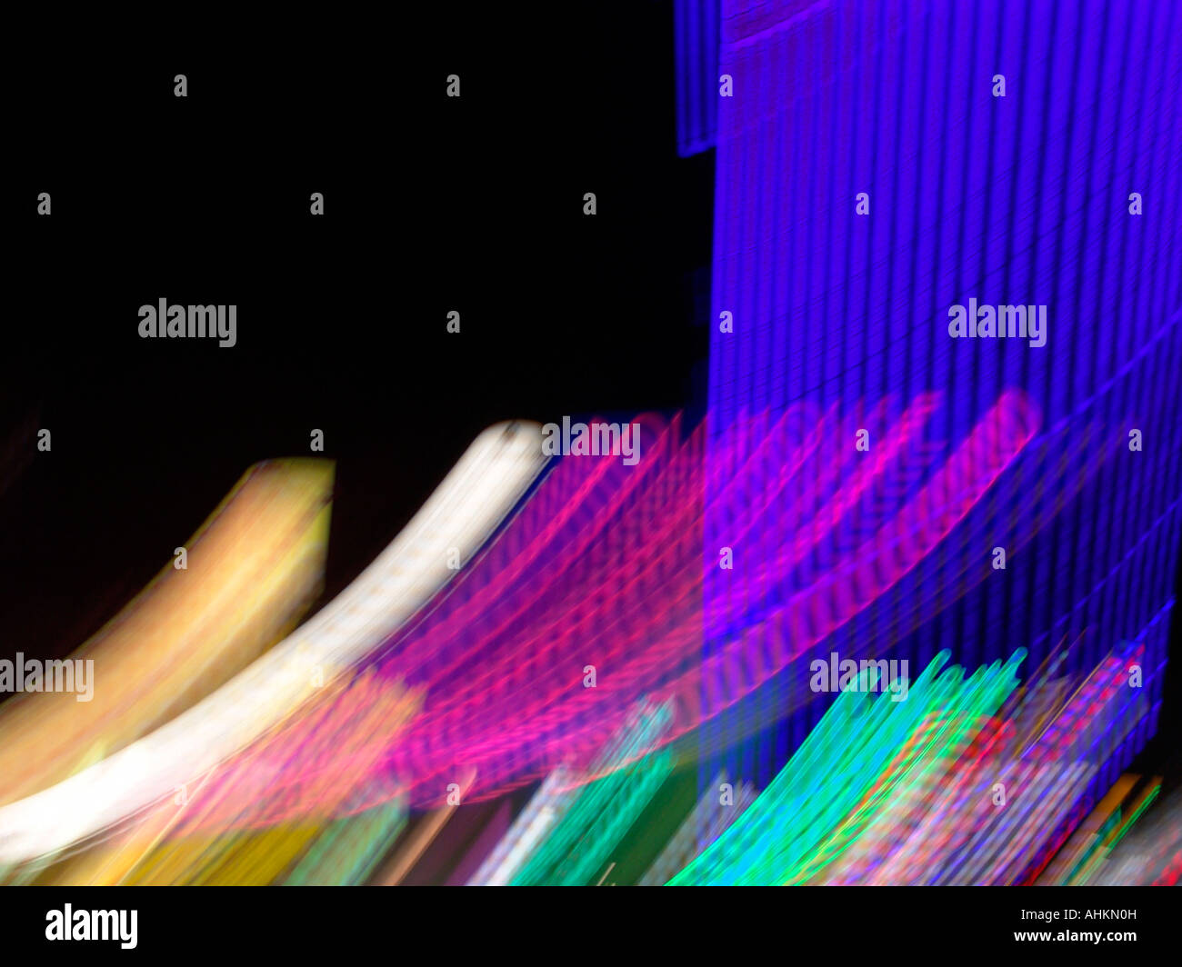 blurred neon signs and rays of light on a street at night Stock Photo ...