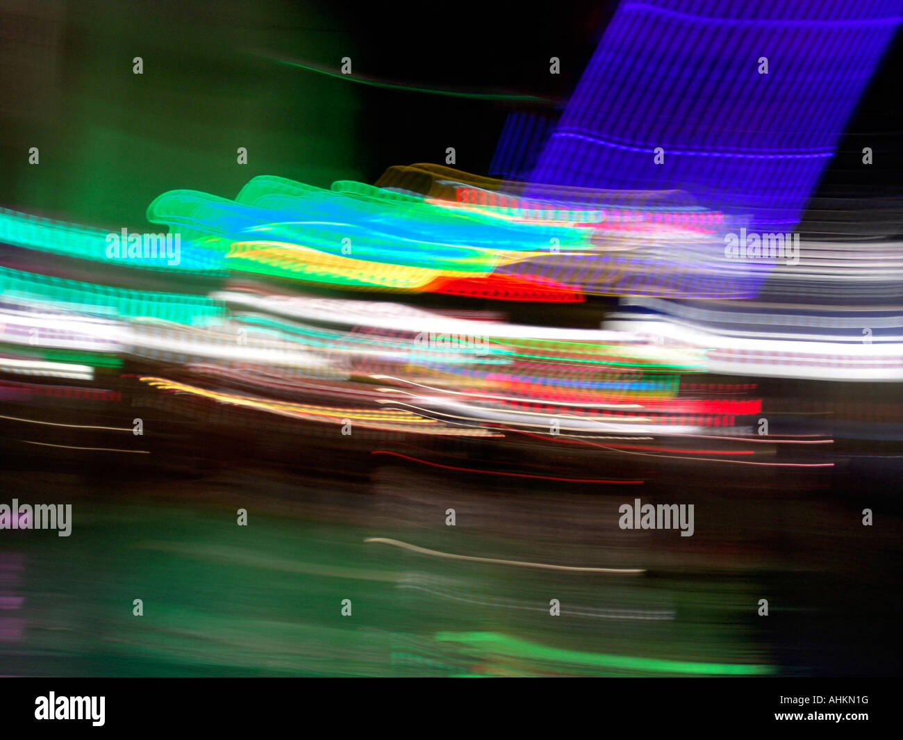 blurred neon signs and rays of light on a street at night Stock Photo ...