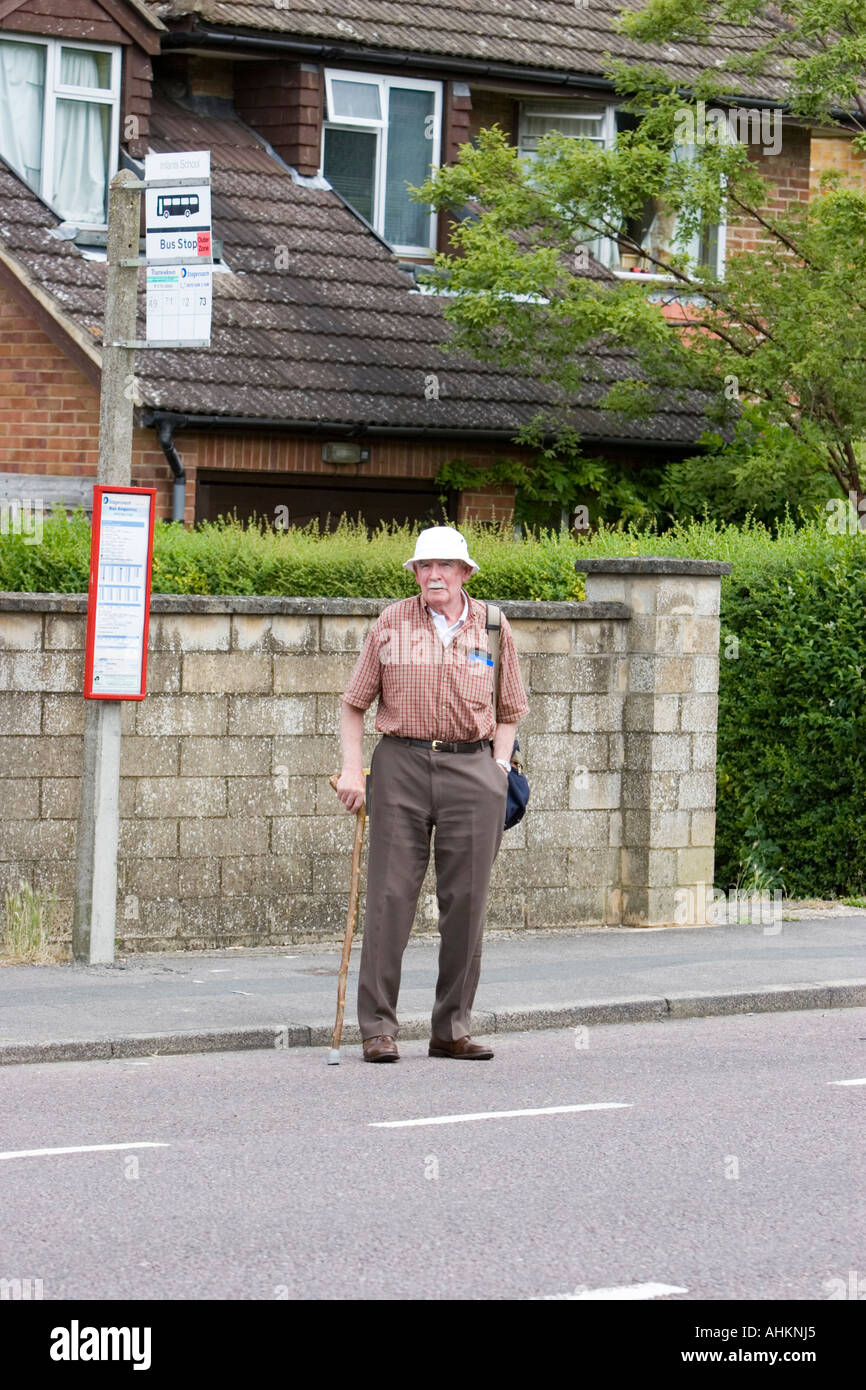 Old man waiting patiently at a bus stop Stock Photo - Alamy