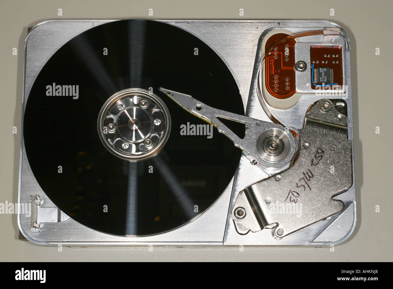 Shot of surface of computer hard disk with magnetic reading arm in ...