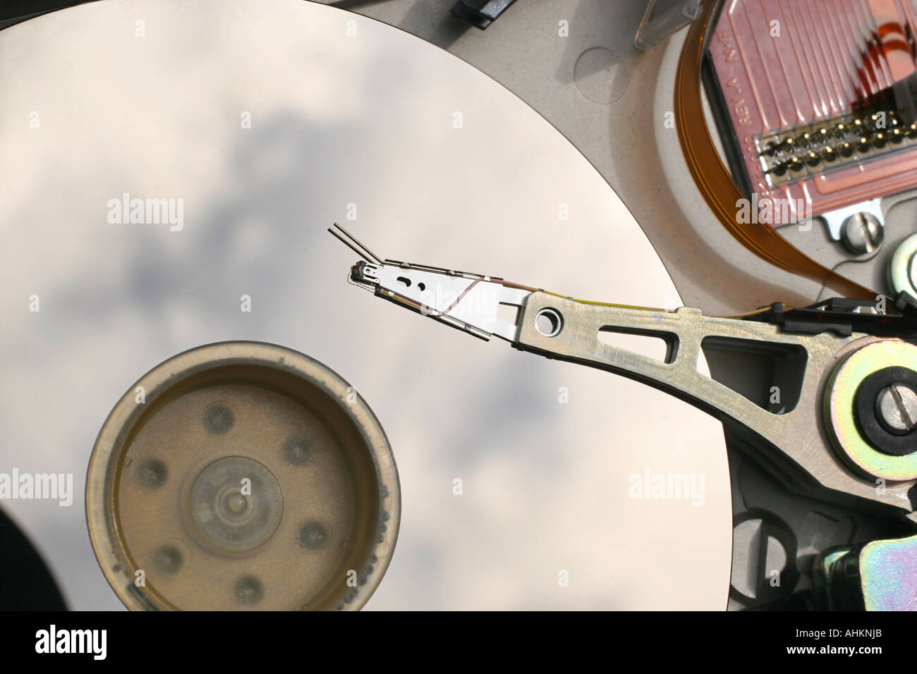 Close shot of surface of computer hard disk with magnetic reading arm ...