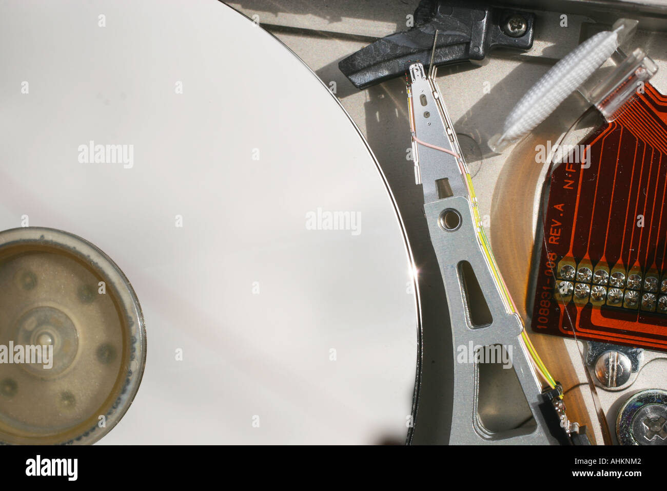 Close shot of surface of computer hard disk with magnetic reading arm ...