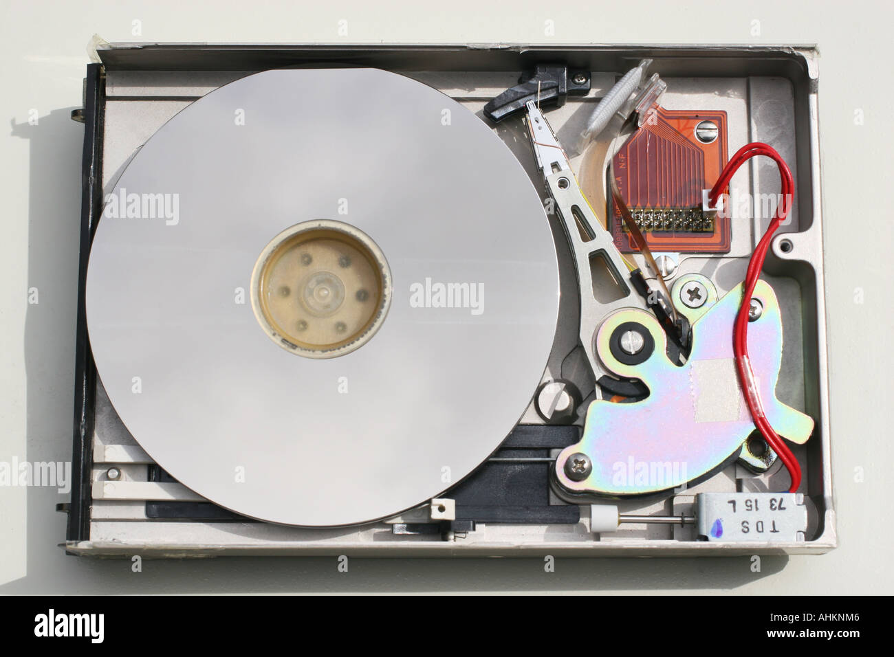 Shot of surface of computer hard disk with magnetic reading arm in ...