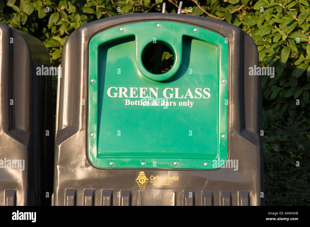 Glass recycling bins in car park Stock Photo - Alamy