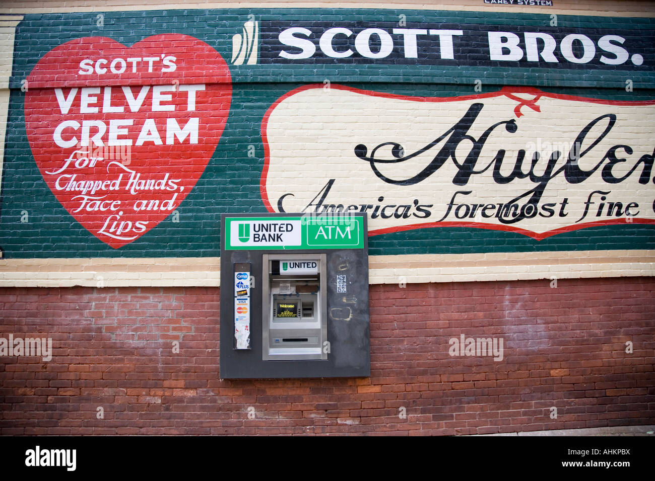 Old and New, Bank ATM machine in wall next to advertisement for old ...