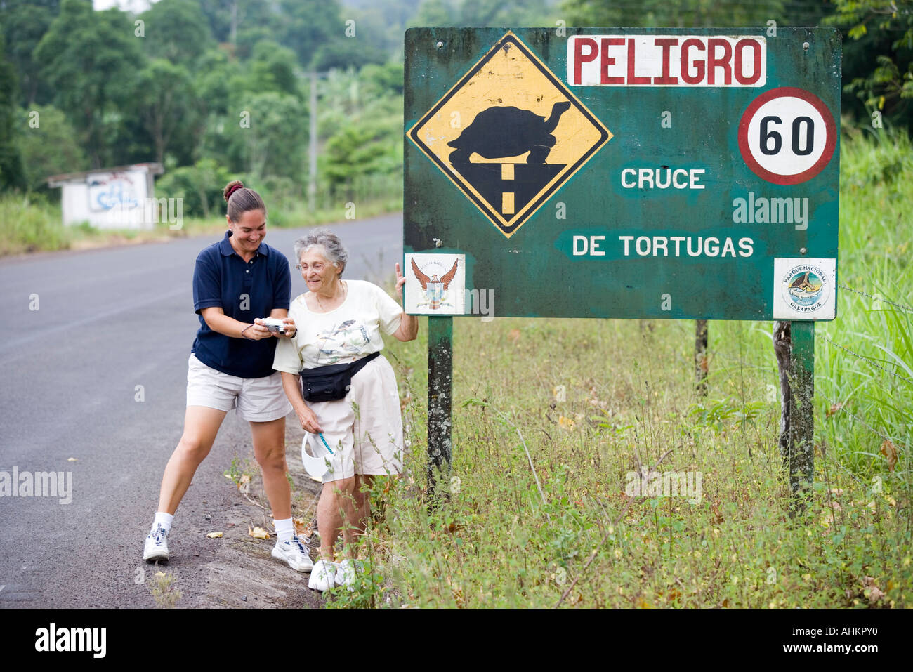 Ecuador Galapagos Islands Tourists pose for snapshots in front of ...