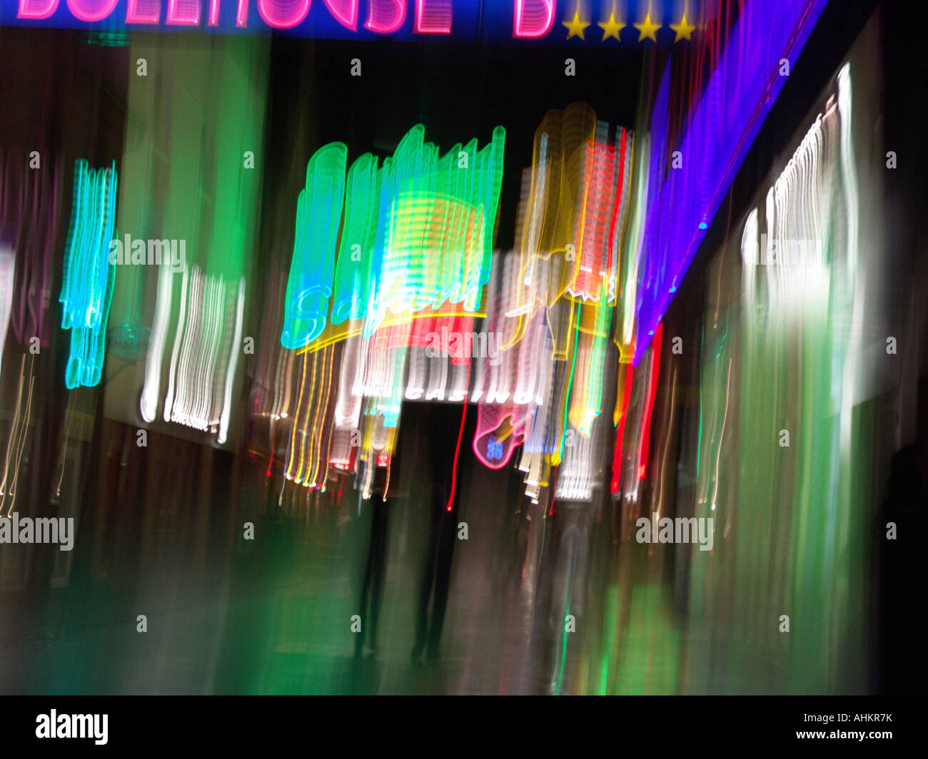 blurred neon signs and rays of light on a street at night Stock Photo ...