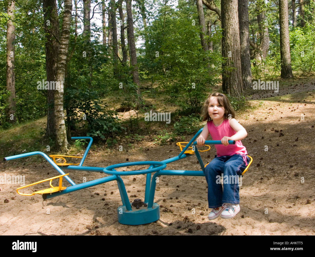 Little girl on a roundabout ride Stock Photo - Alamy