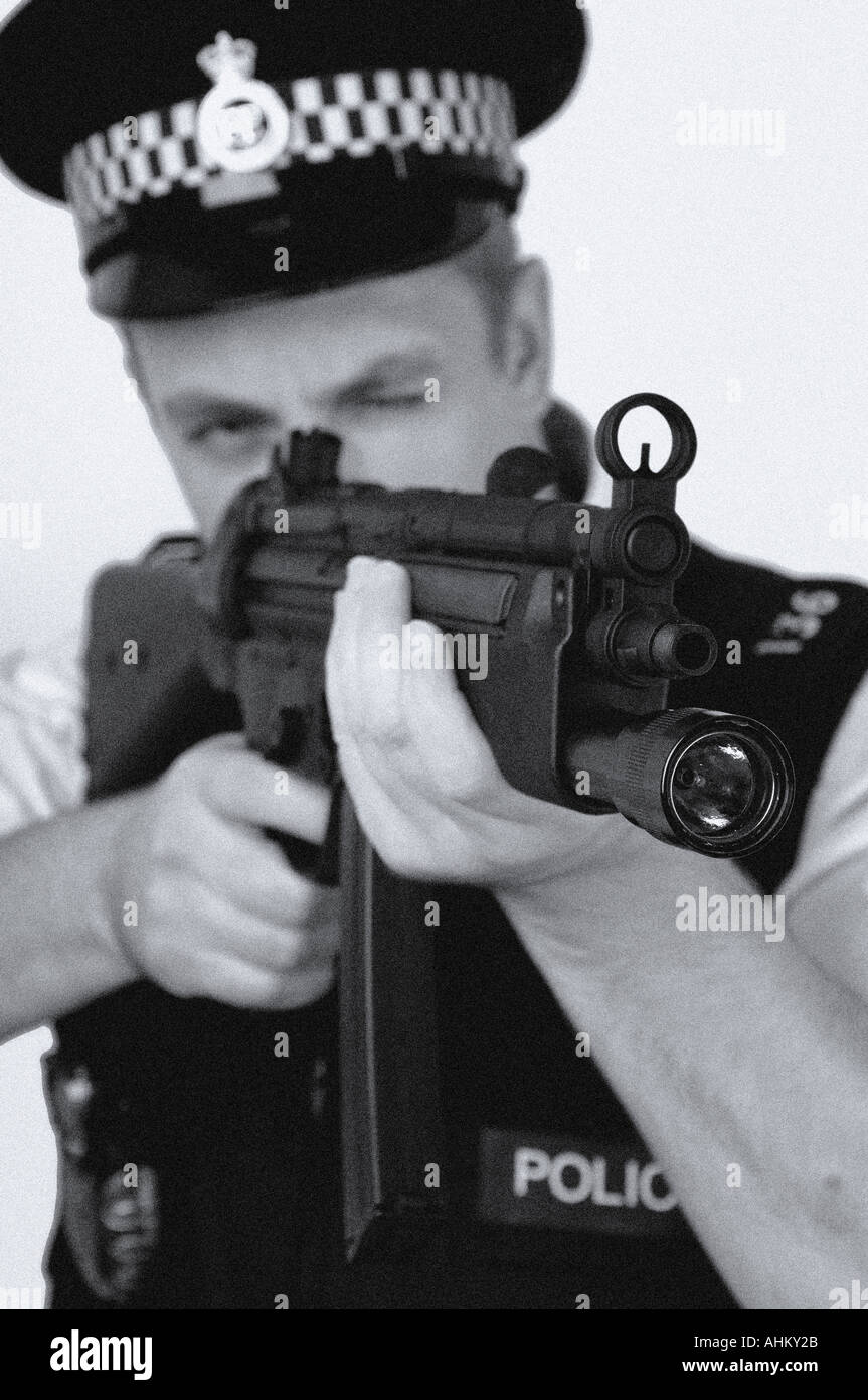 an armed police officer in uniform with a heckler kock MP5 automatic ...