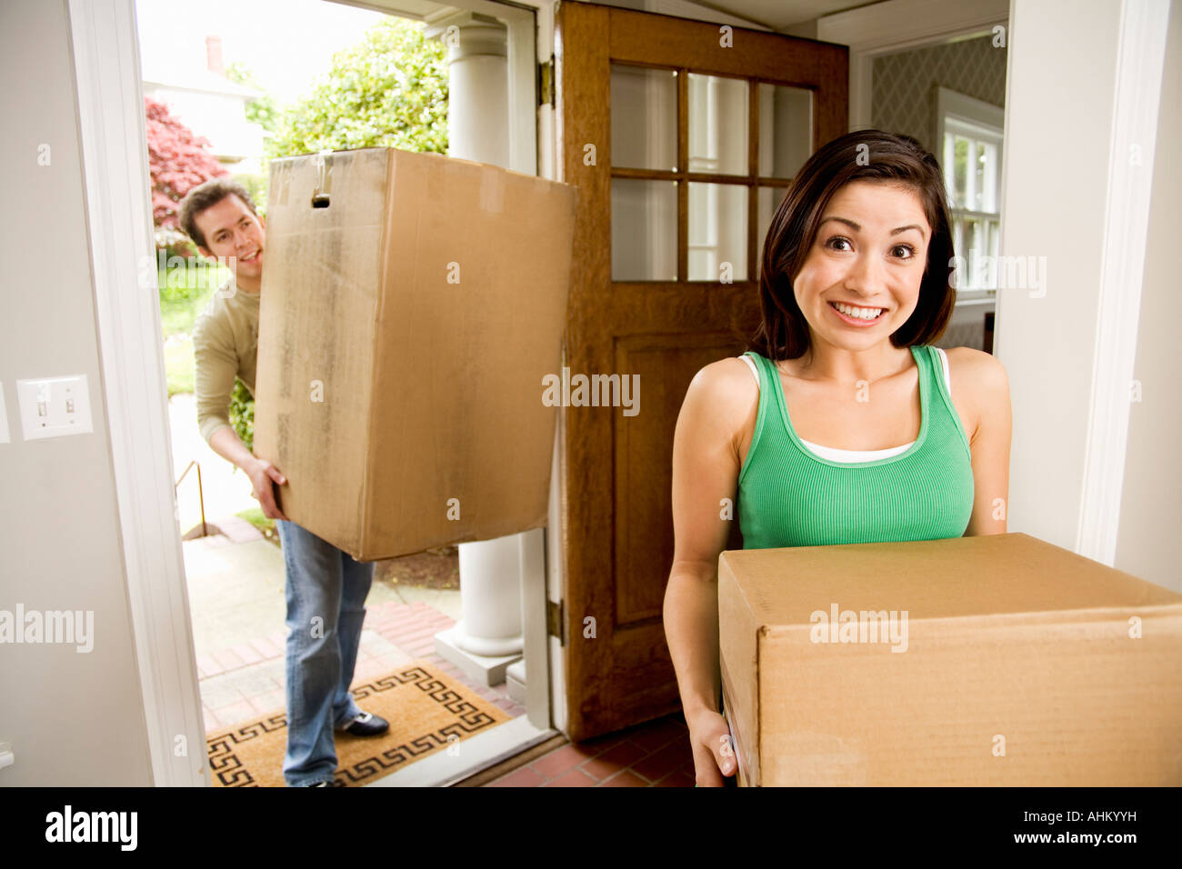 Couple carrying moving boxes Stock Photo - Alamy