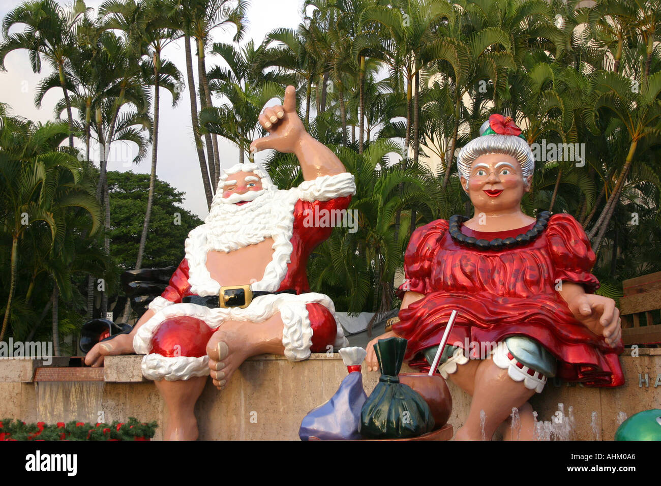 Hawaiian Santa Claus and Mrs Claus atop a fountain in Honolulu Hawaii ...