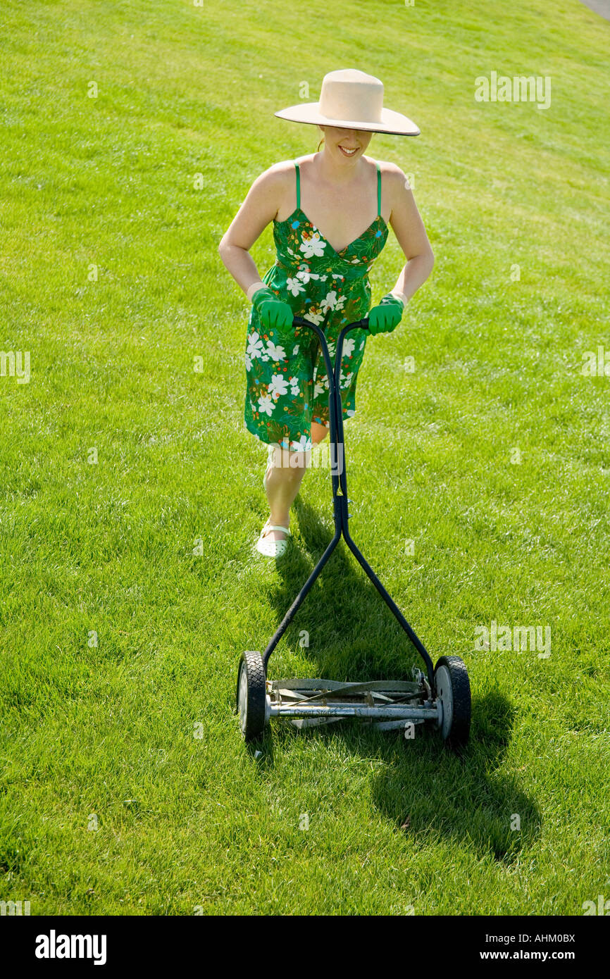 Woman pushing lawn mower Stock Photo - Alamy