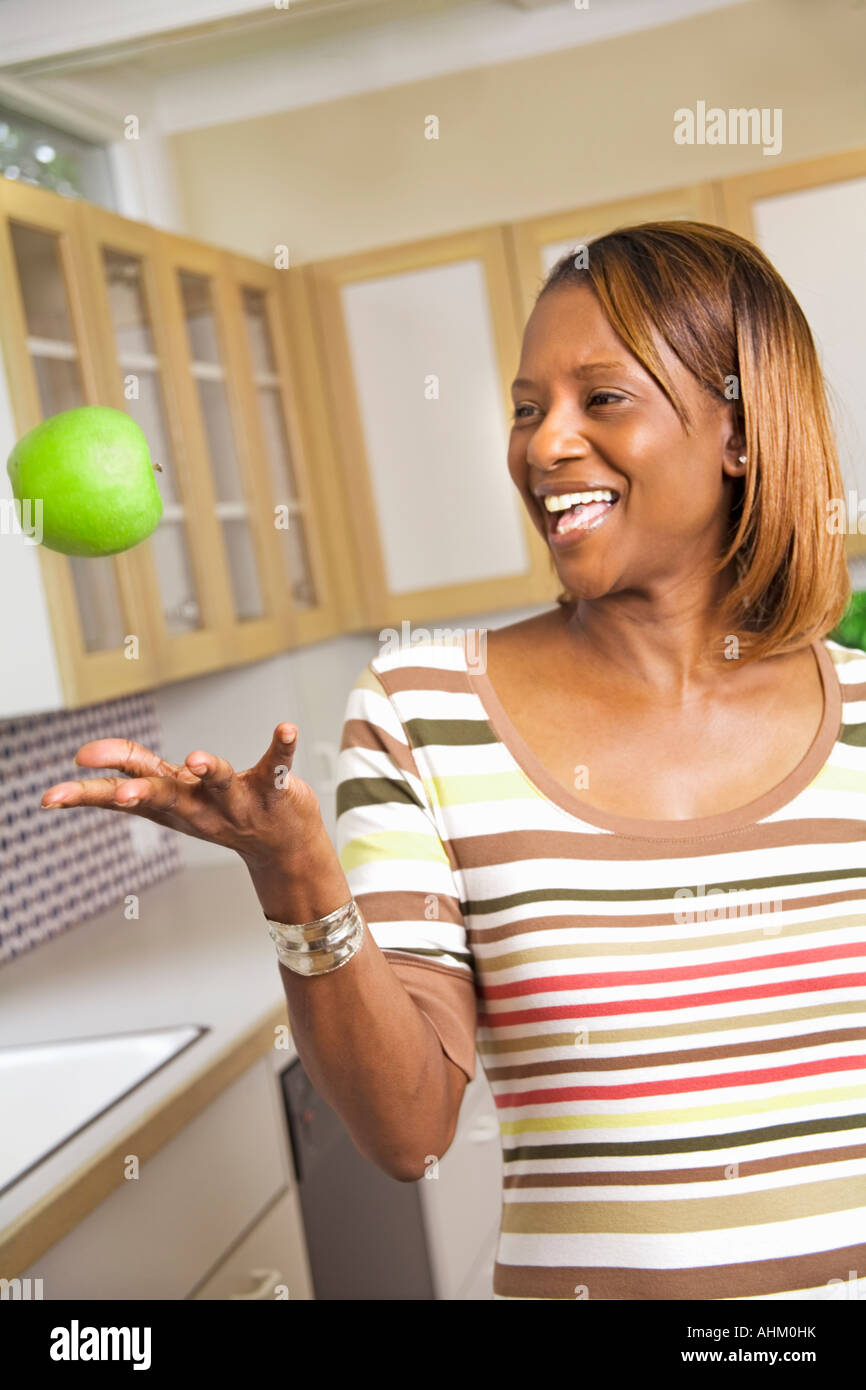 African woman throwing apple Stock Photo - Alamy