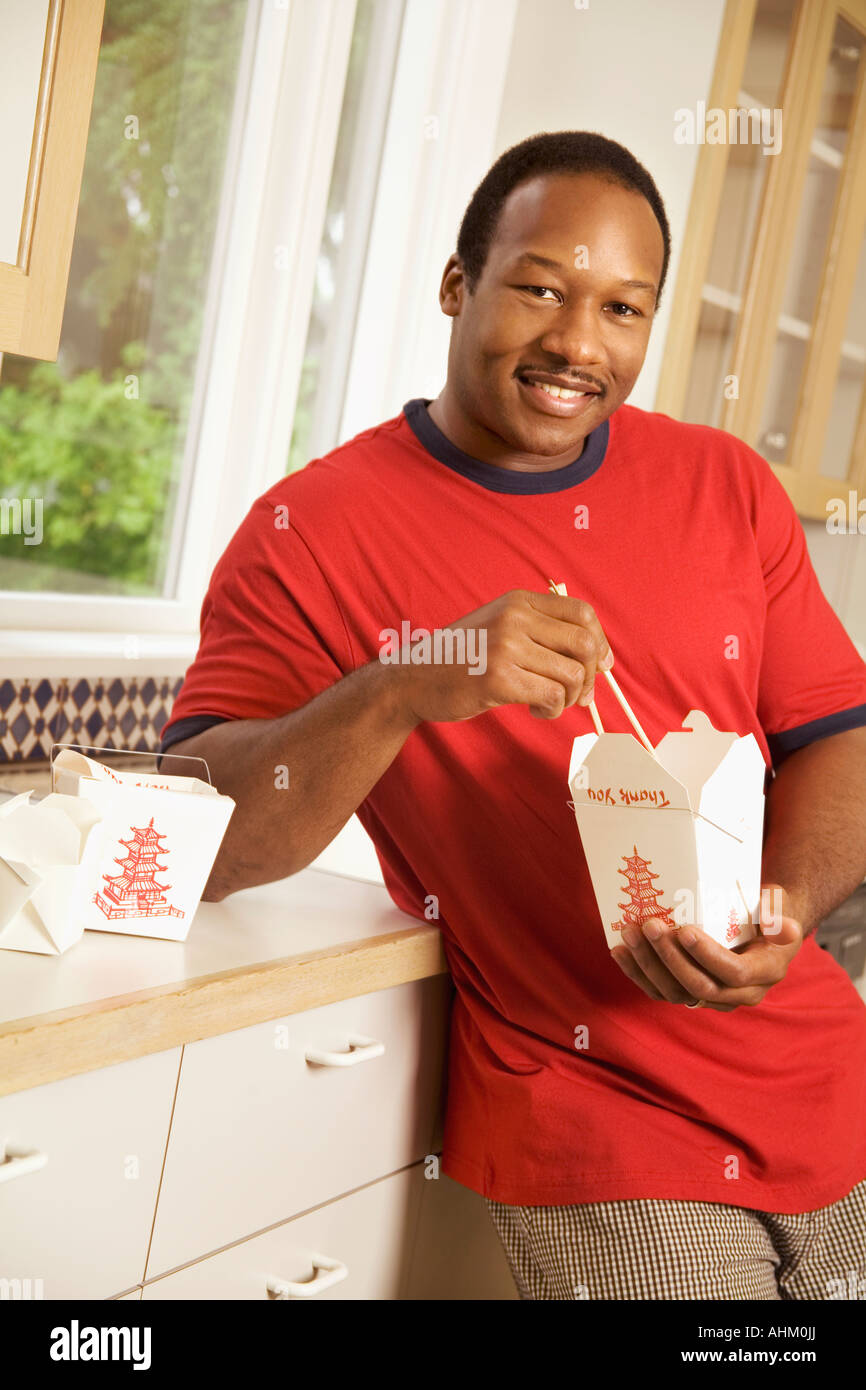 African man eating take out food Stock Photo - Alamy