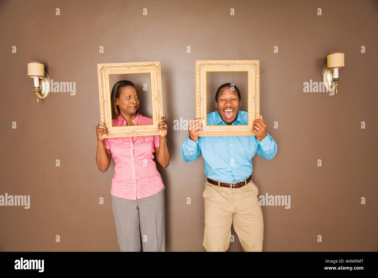 African couple looking through picture frames Stock Photo - Alamy