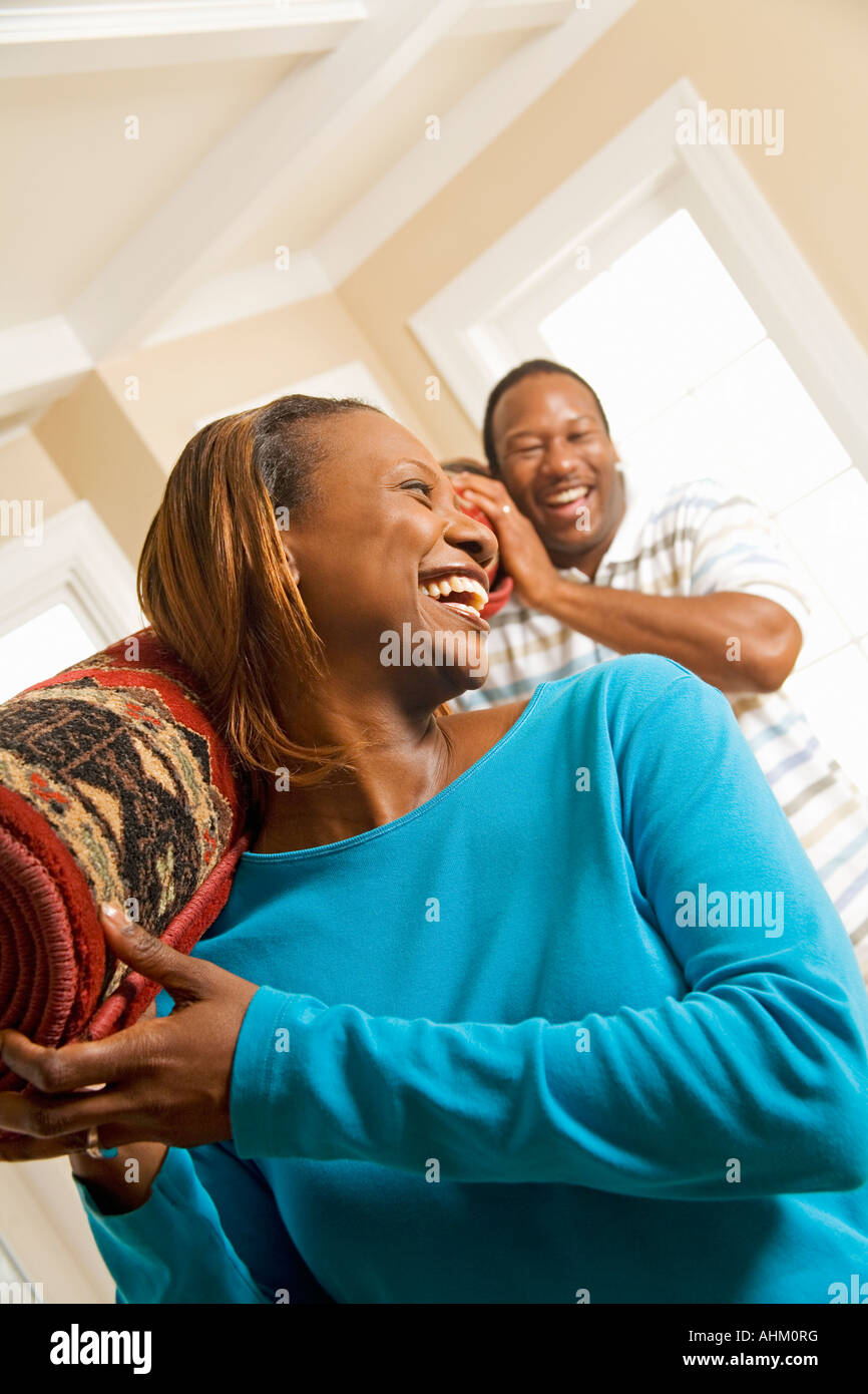 African couple carrying rug Stock Photo - Alamy