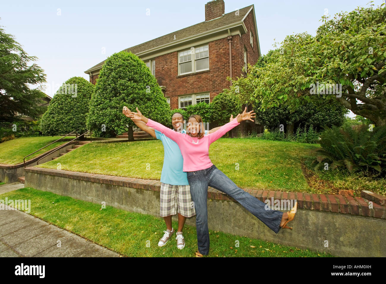 African couple in front of new house Stock Photo - Alamy