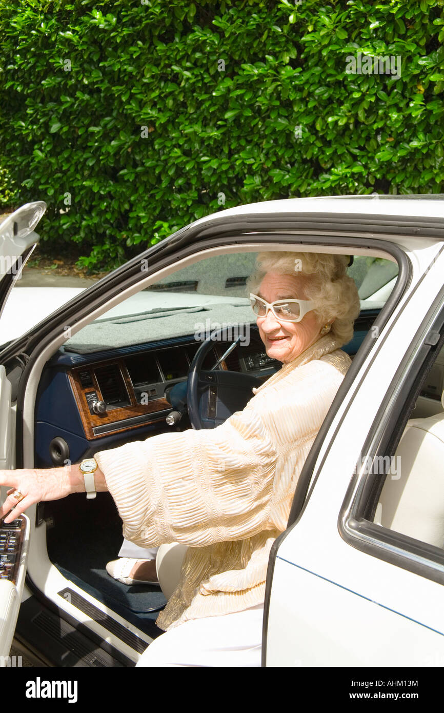 Senior woman getting into car Stock Photo - Alamy