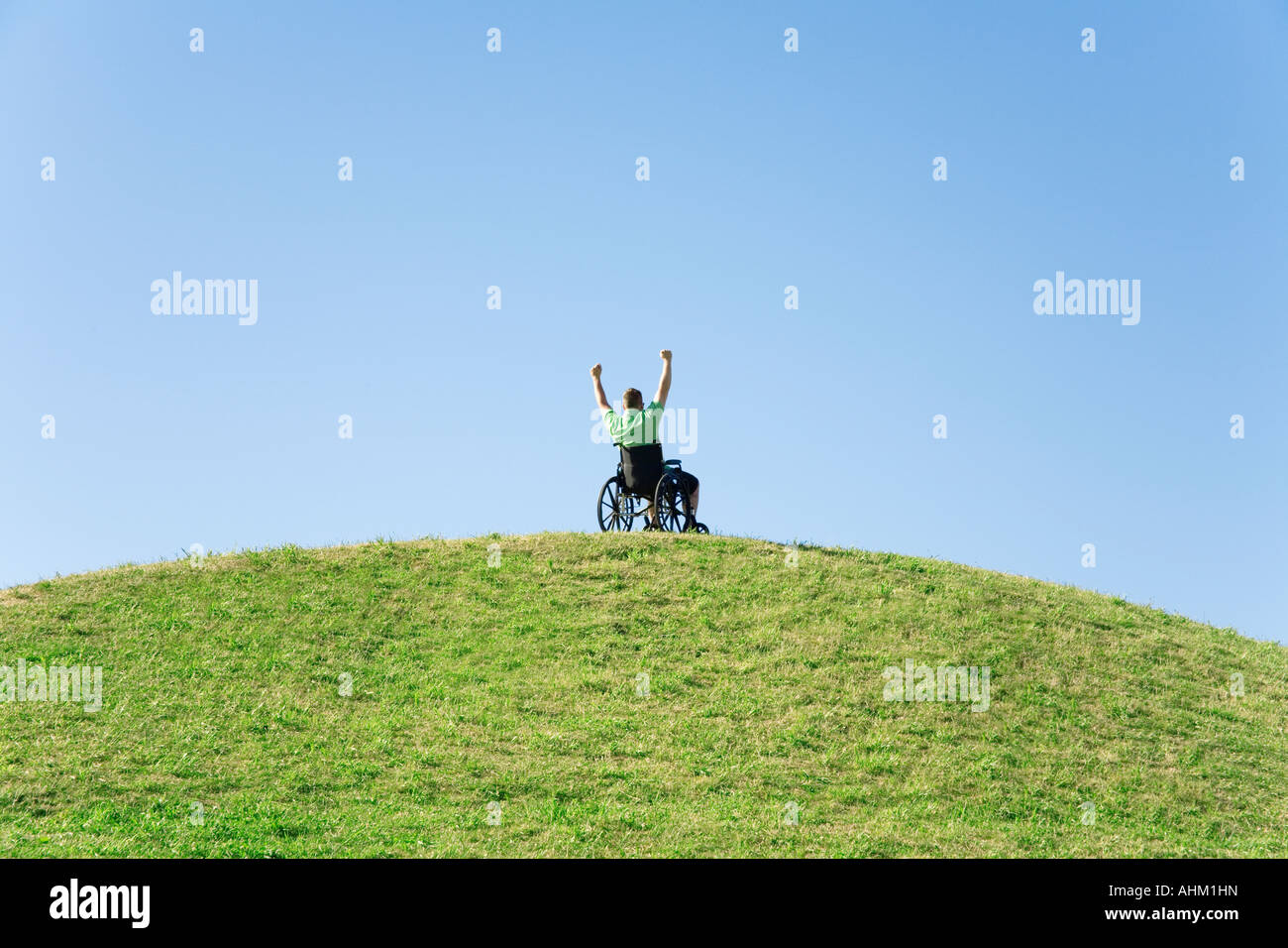 Person in wheelchair on top of hill Stock Photo - Alamy