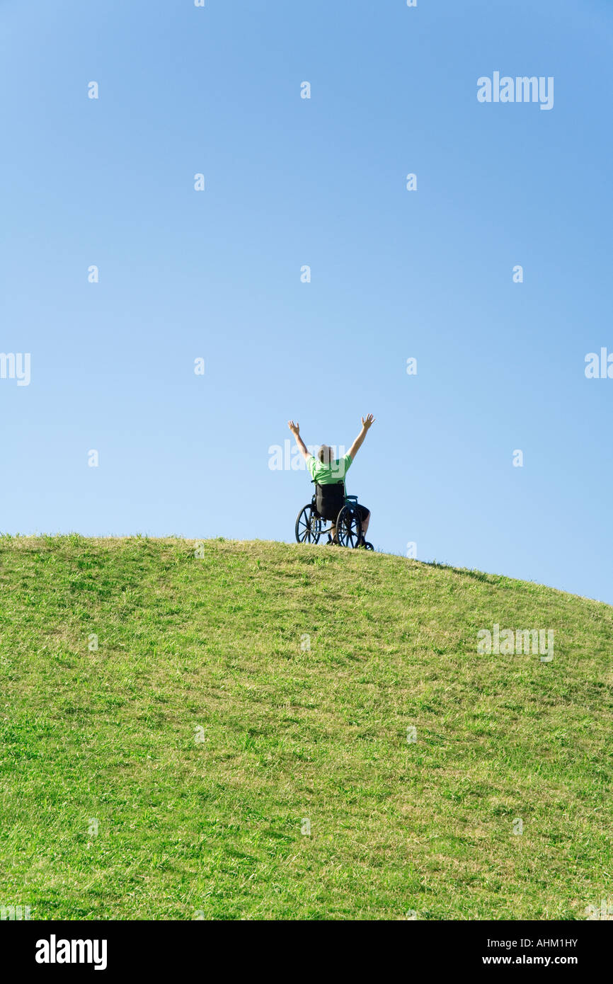 Person in wheelchair on top of hill Stock Photo - Alamy