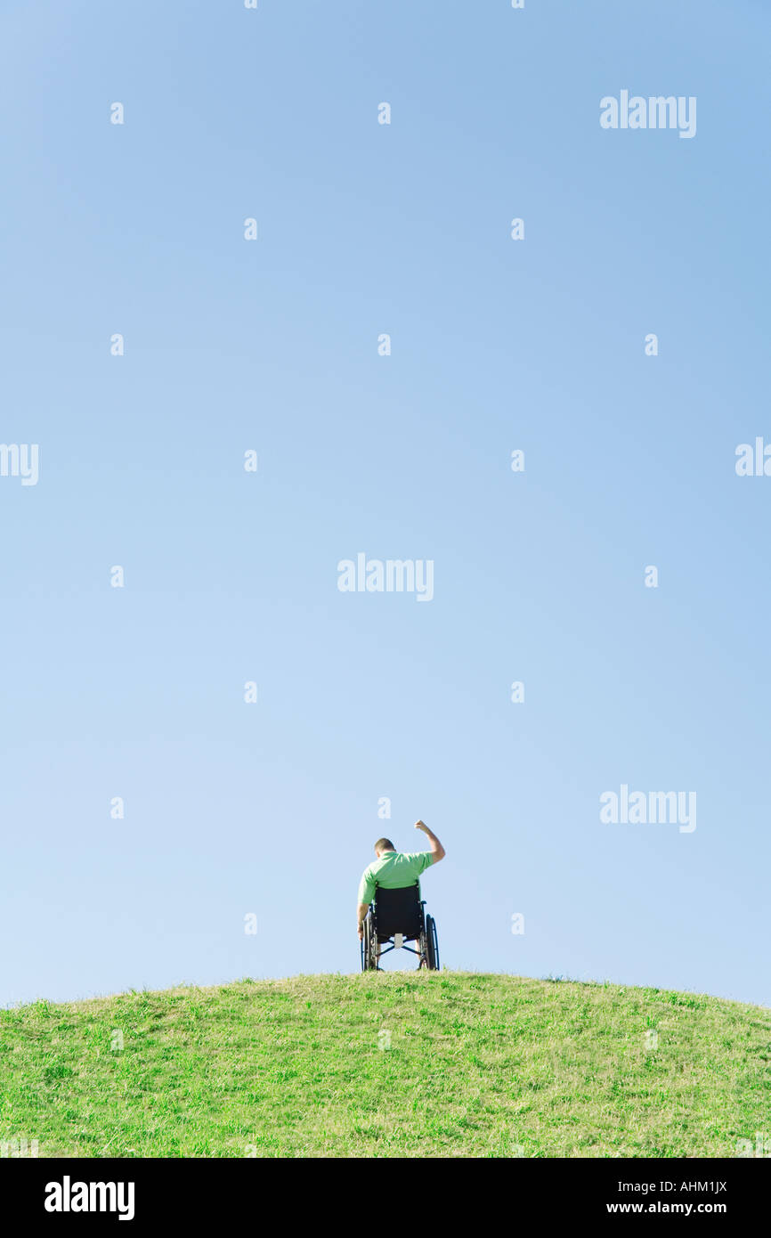 Person in wheelchair on top of hill Stock Photo - Alamy