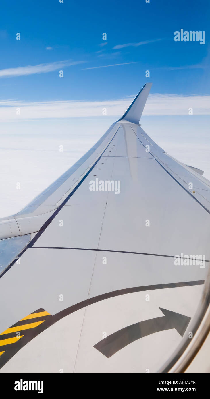 Vertical panoramic shot of an airliner wing in flight Stock Photo - Alamy