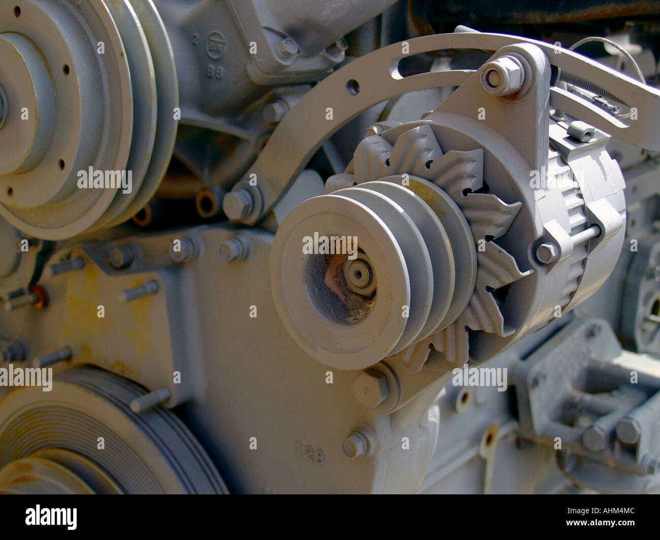 Close view of a large grey industrial engine showing various machinery ...