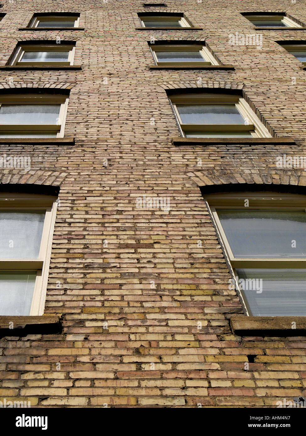 Wideangle view of windows on the side of a brick and mortar urban ...