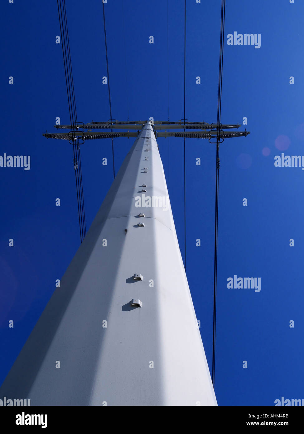 Large power line towers carrying power mains stretching across a deep ...