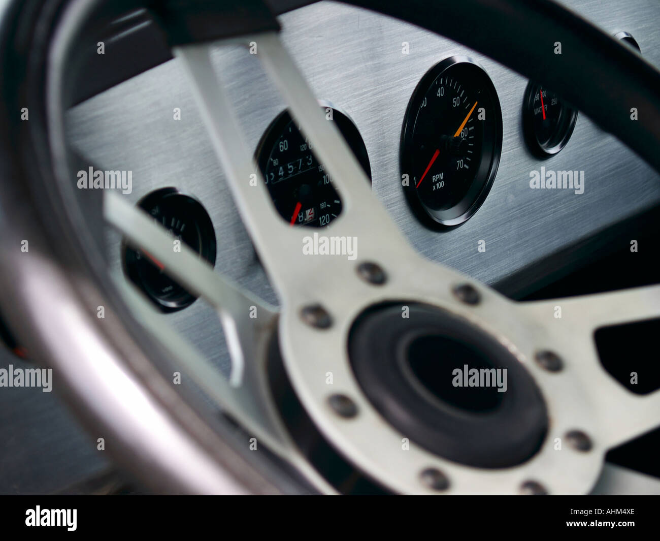 Racing steering wheel and utility gauges in the cockpit of a hot rod ...