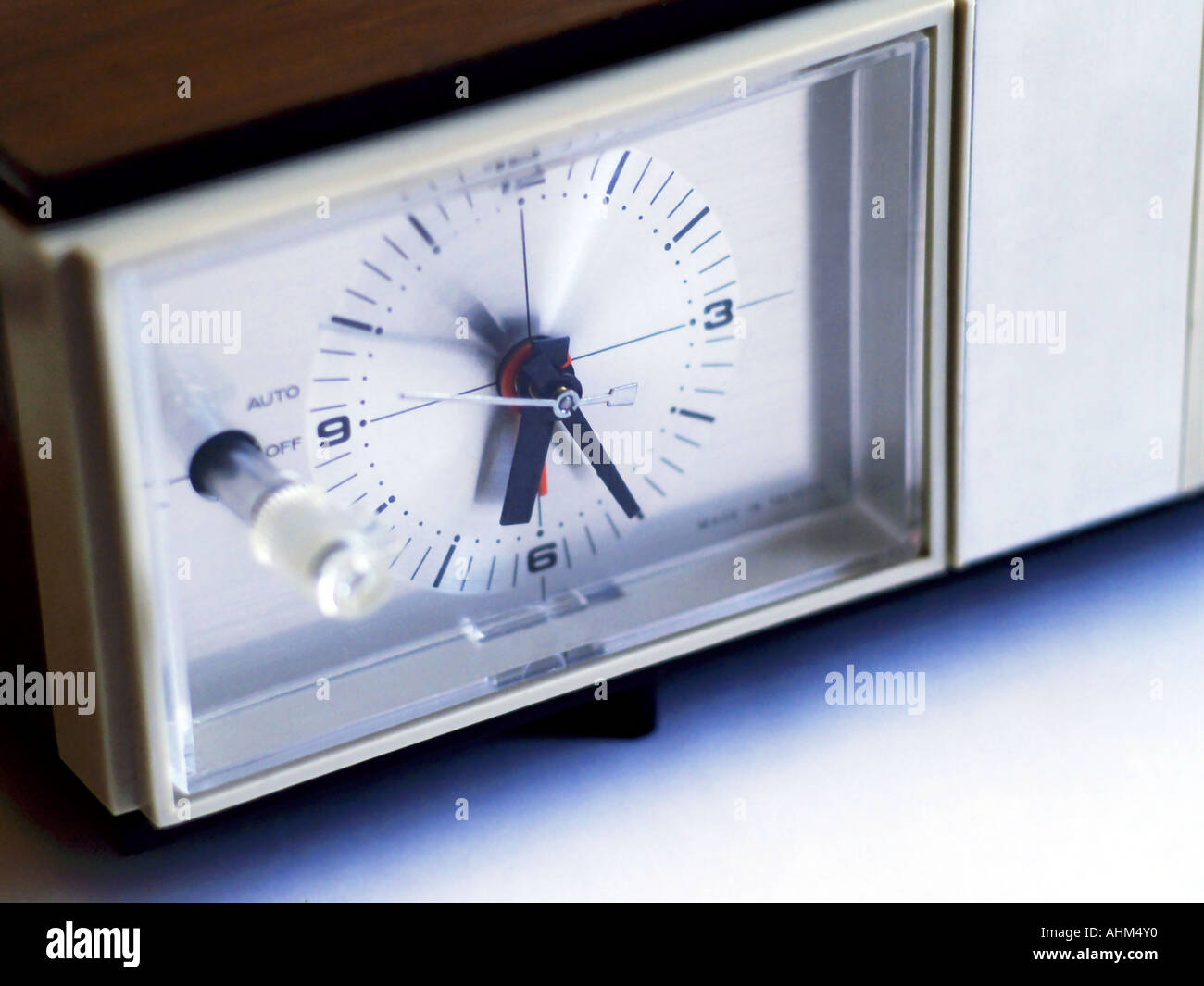 Vintage silver colored square clock face in soft light showing a time ...