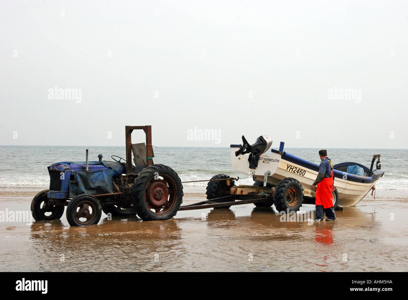 Getting the fishing boat out of the sea Stock Photo - Alamy