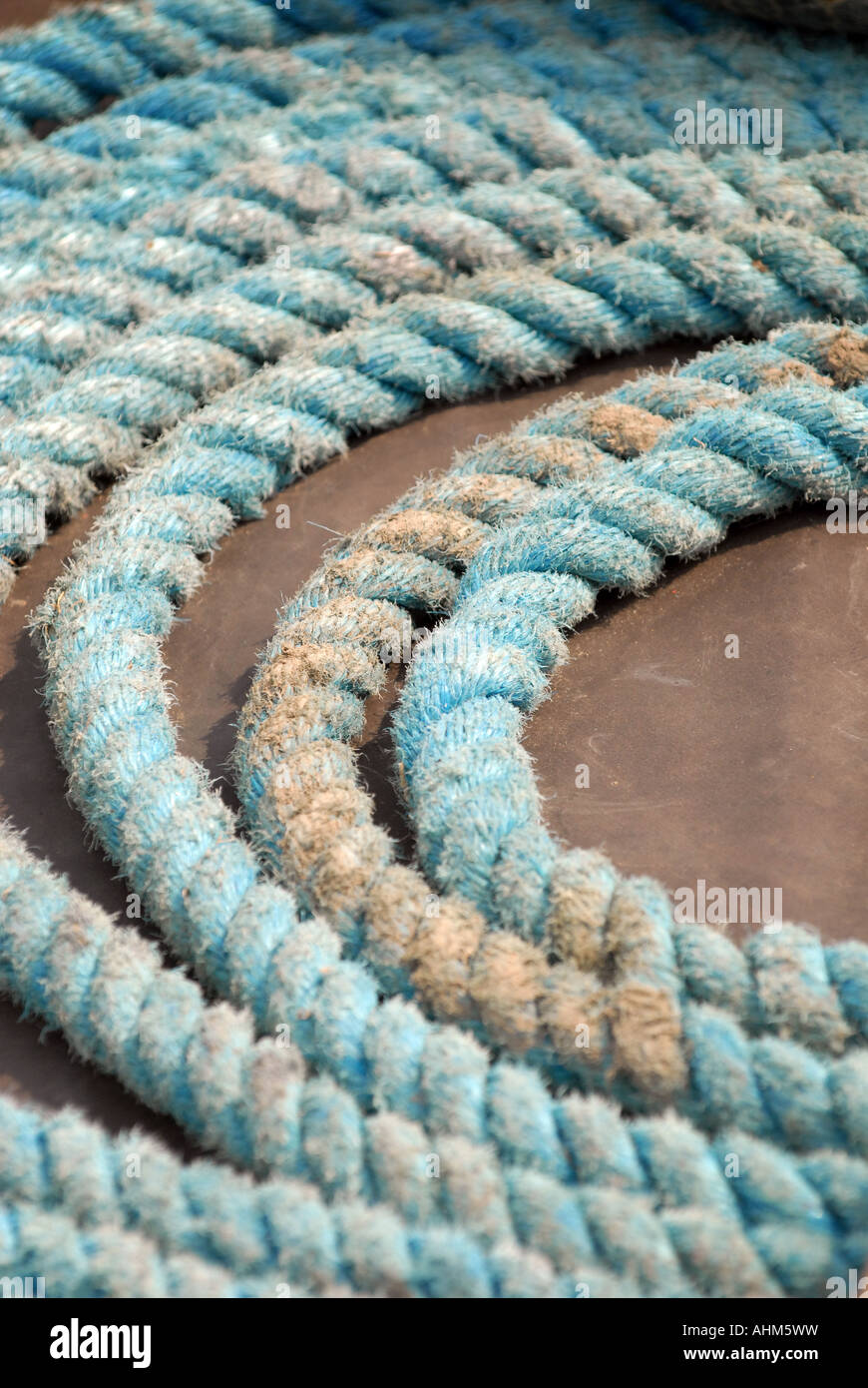 Coiled blue rope on the deck of a boat Stock Photo - Alamy
