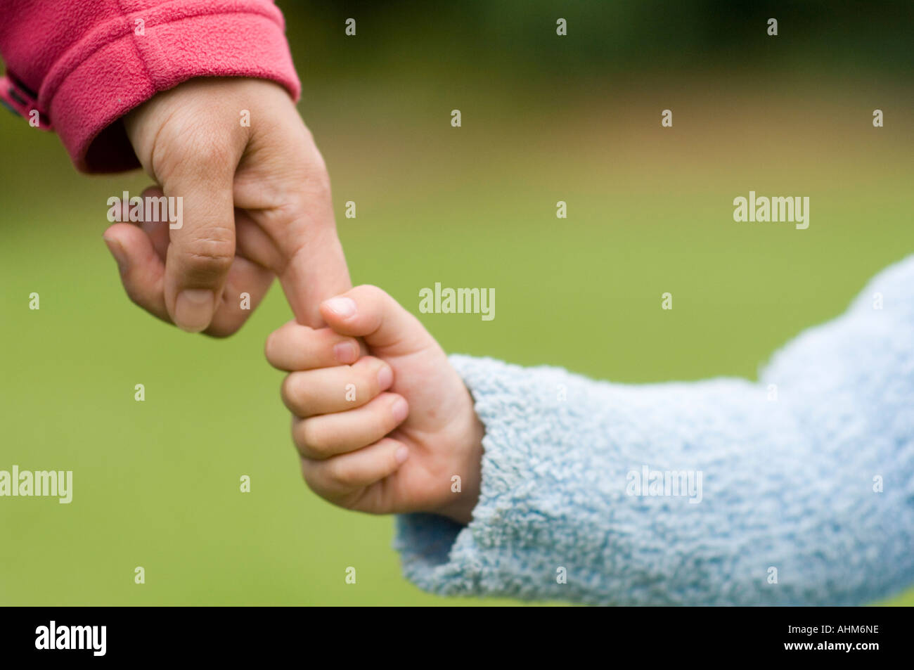 Child holding finger of mother s hand Stock Photo - Alamy