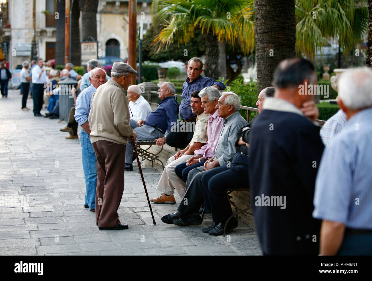 Local men sitting on a bench Noto Sicily Italy Stock Photo - Alamy