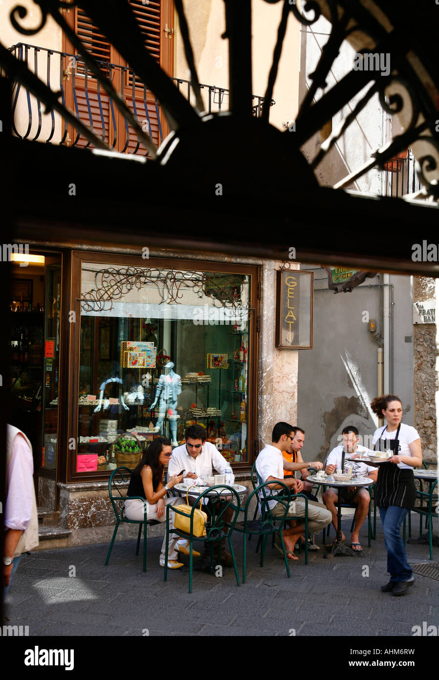 People sitting at an outdoors cafe in Taormina Sicily Italy Stock Photo ...