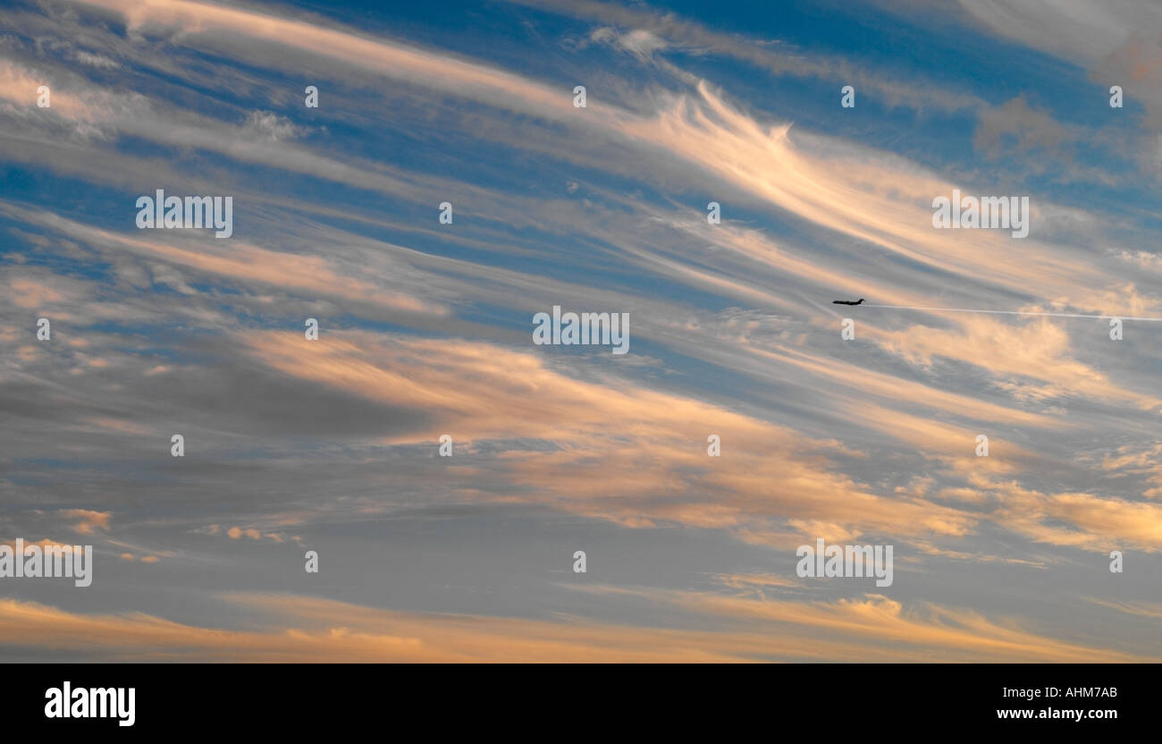 Aircraft flying across a dramatic sky Stock Photo - Alamy