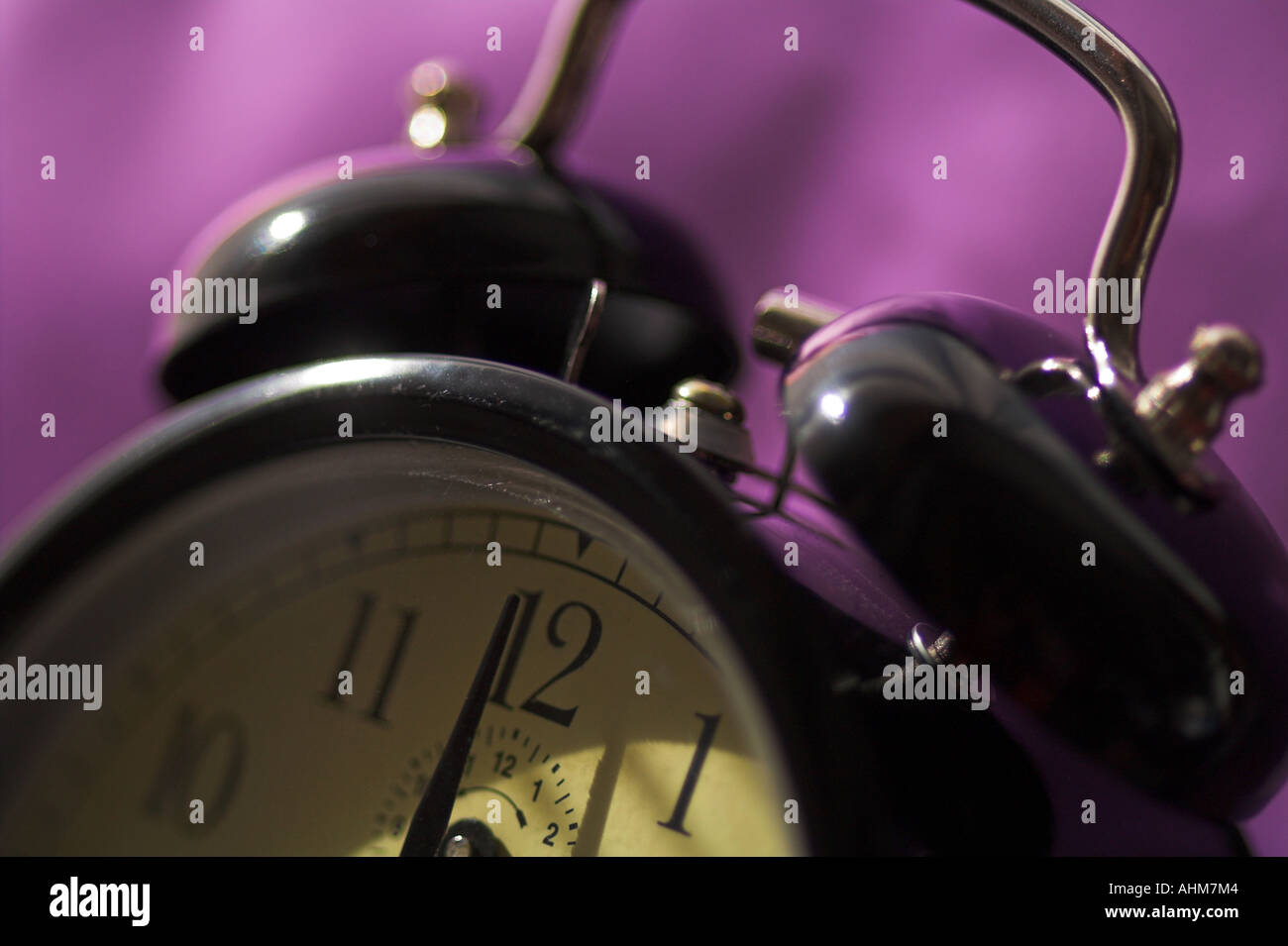 Close-up of clock with hands near 12 o'clock with sun light on the ...