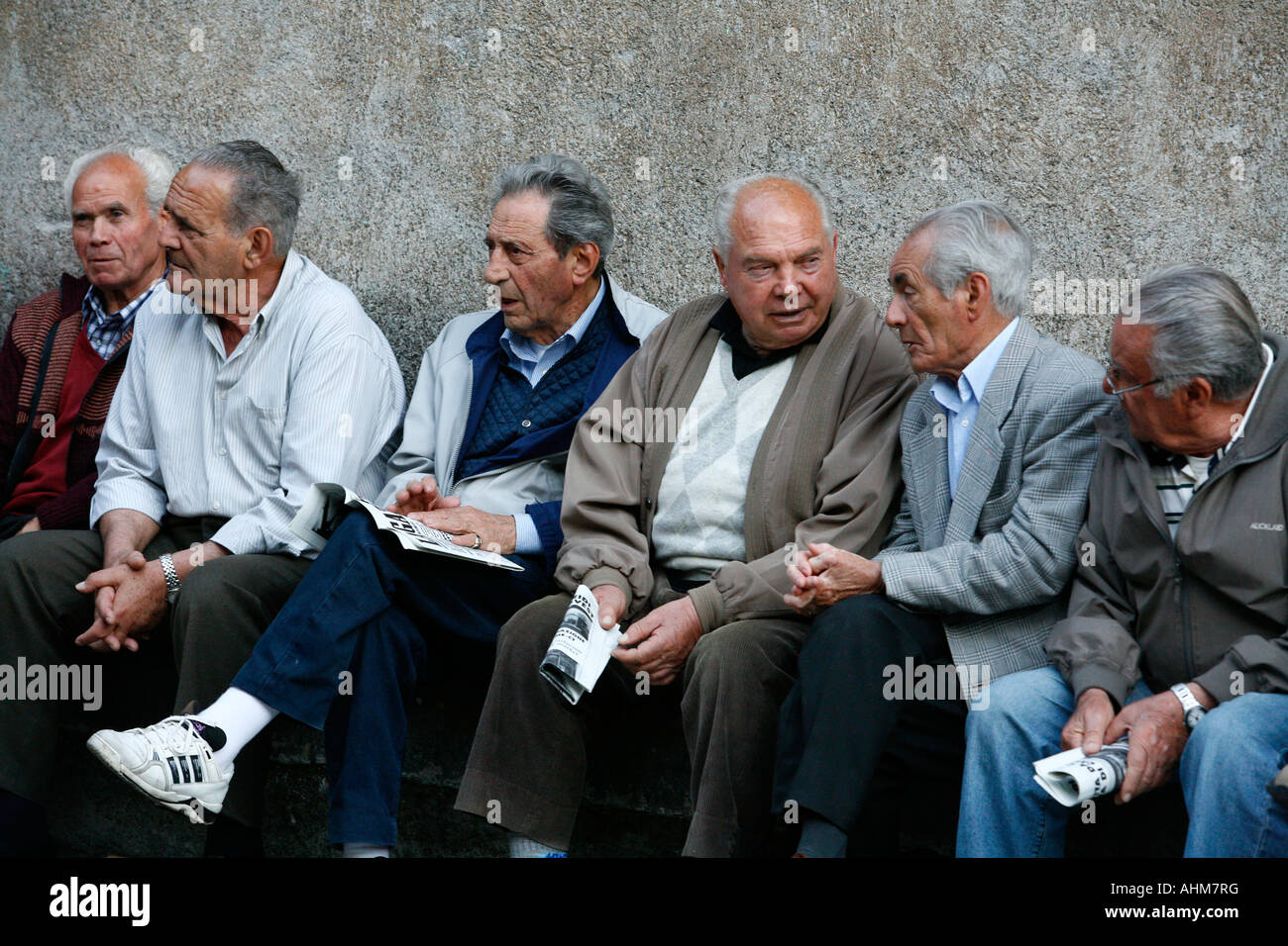 Local Men sitting on a bench Taormina Sicily Italy Stock Photo - Alamy