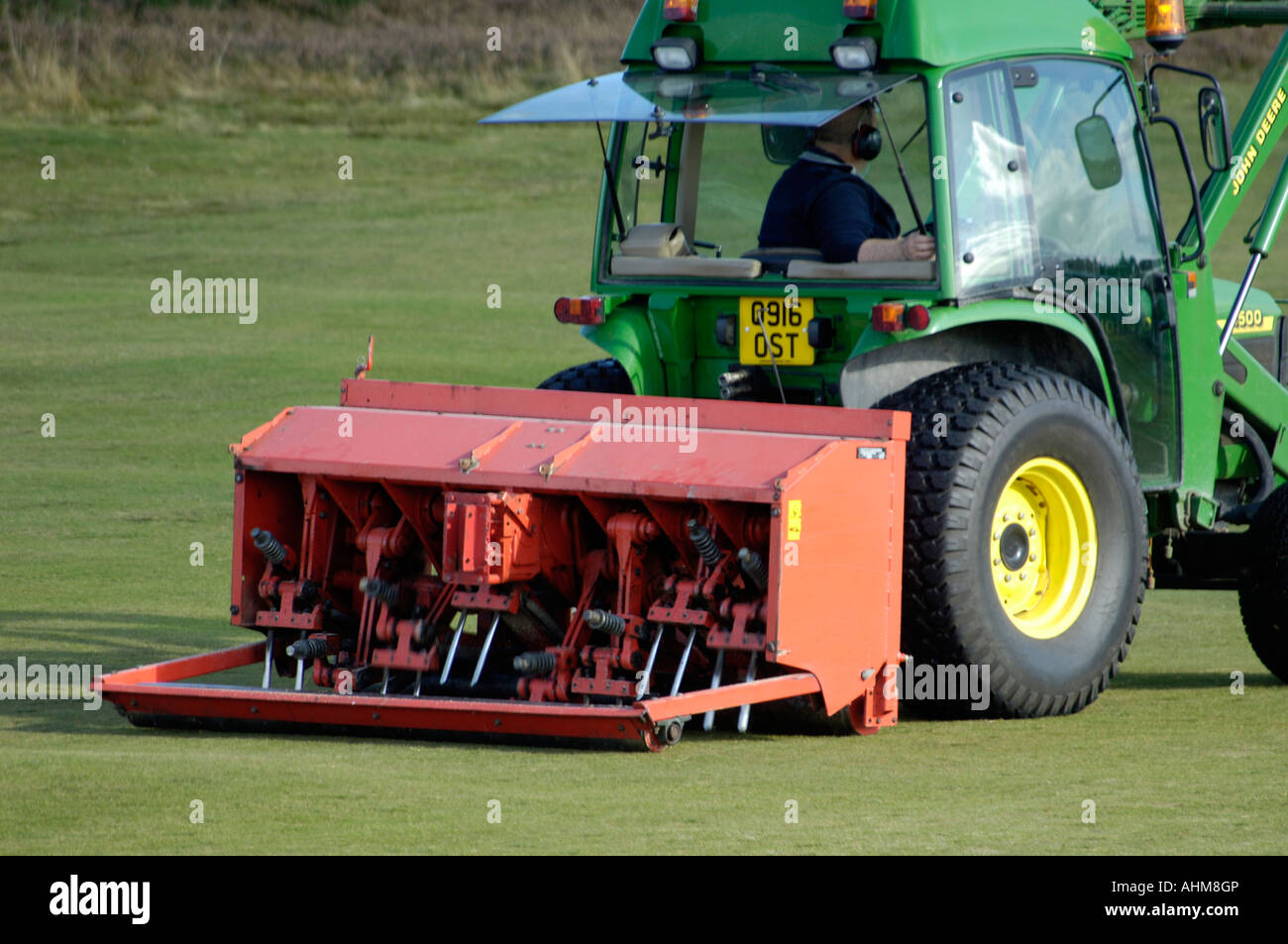 Golf course management by aerating the fairway Stock Photo - Alamy