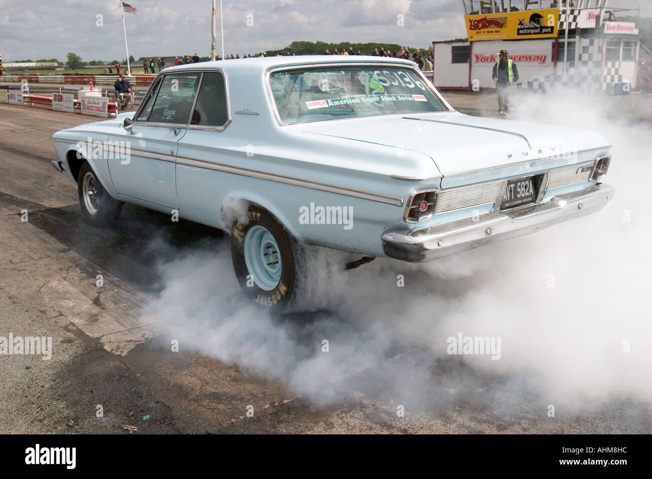 Heavily modified American muscle car doing a burnout prior to a drag ...
