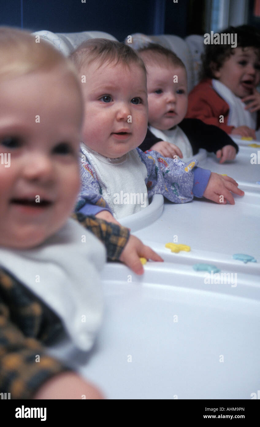 row of babies in high chairs waiting for food Stock Photo - Alamy