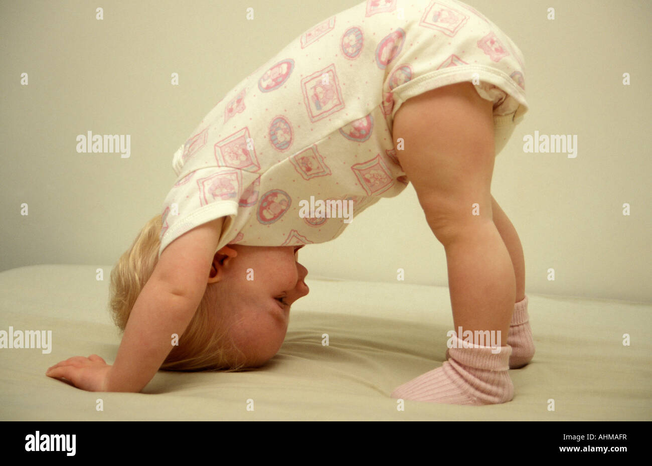 little baby showing how she can bend over Stock Photo - Alamy