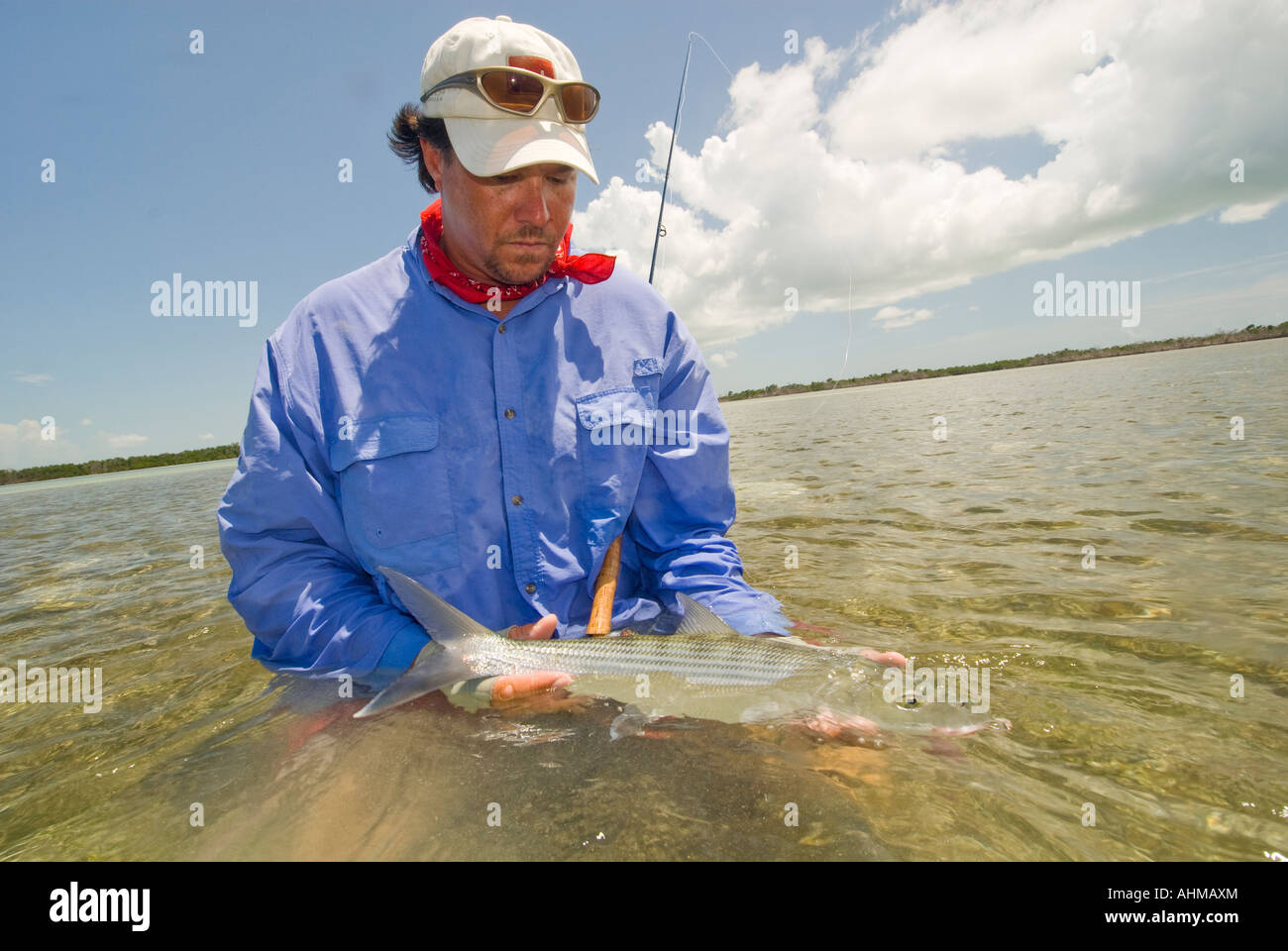 Florida Keys Fly fisherman releasing bonefish caught while fly-fishing ...