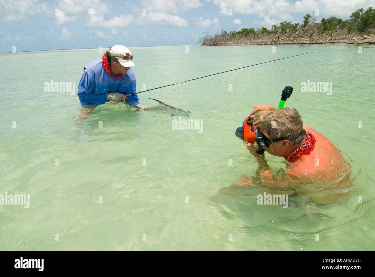 Florida Keys Fisherman releasing Permit Fish while being photograped by ...