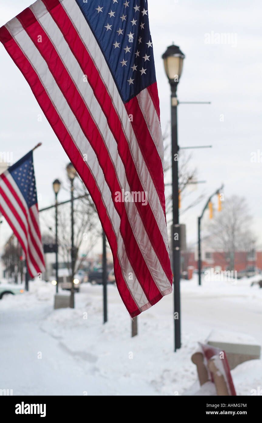 United States flags over a snow covered small town Stock Photo - Alamy