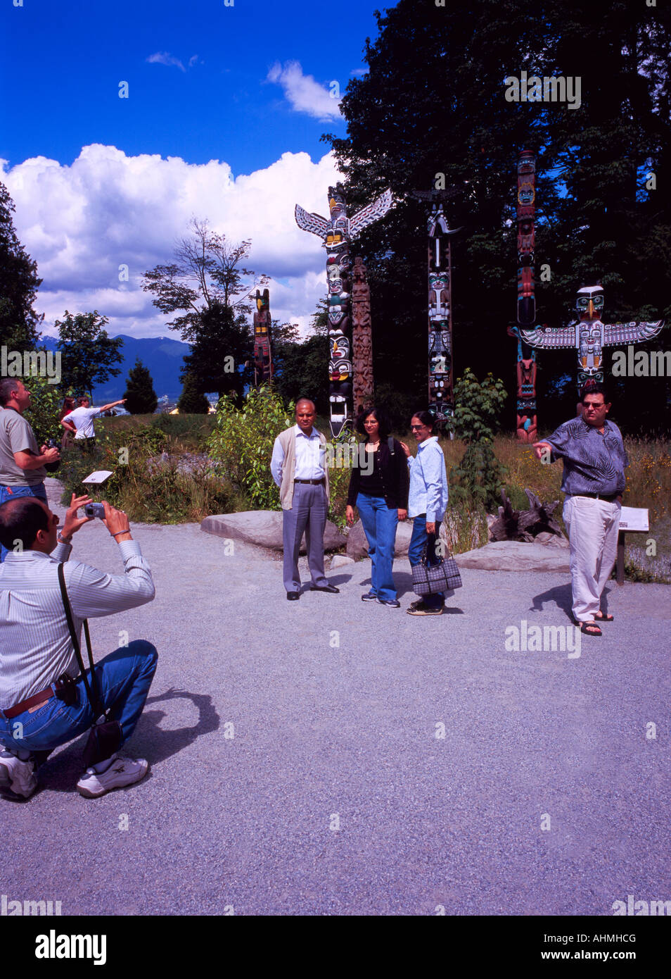 Tourists taking a Picture at the Totem Poles at Brockton Point in ...