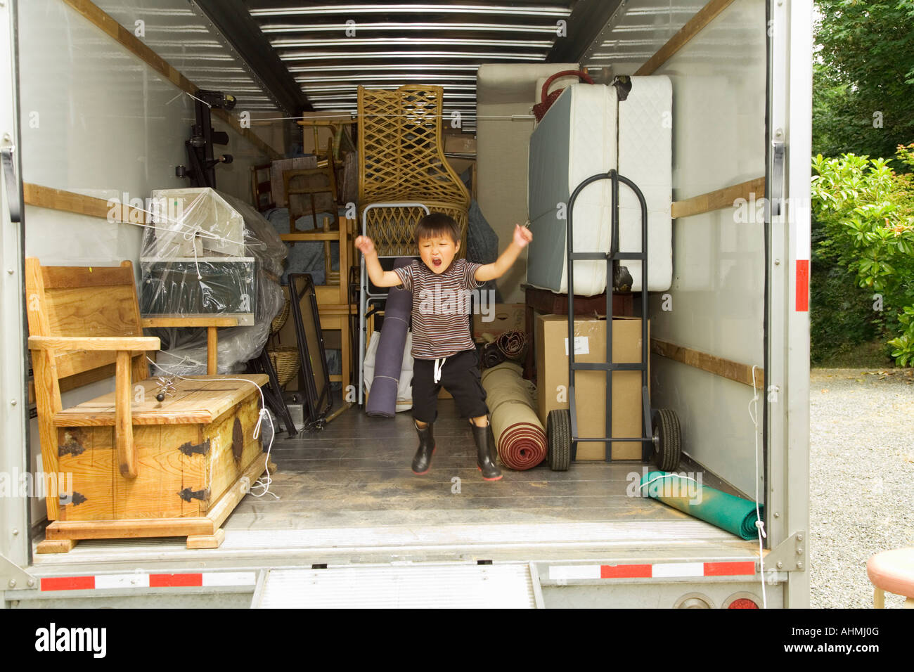 Boy jumping in moving truck Stock Photo - Alamy